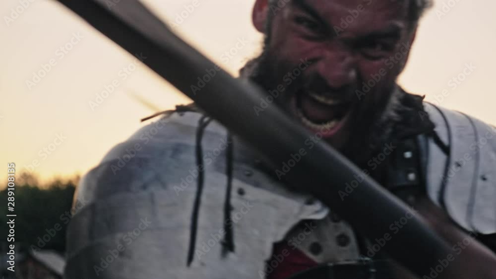 Angry knight going on camera and brandish with hammer. Close-up of ...