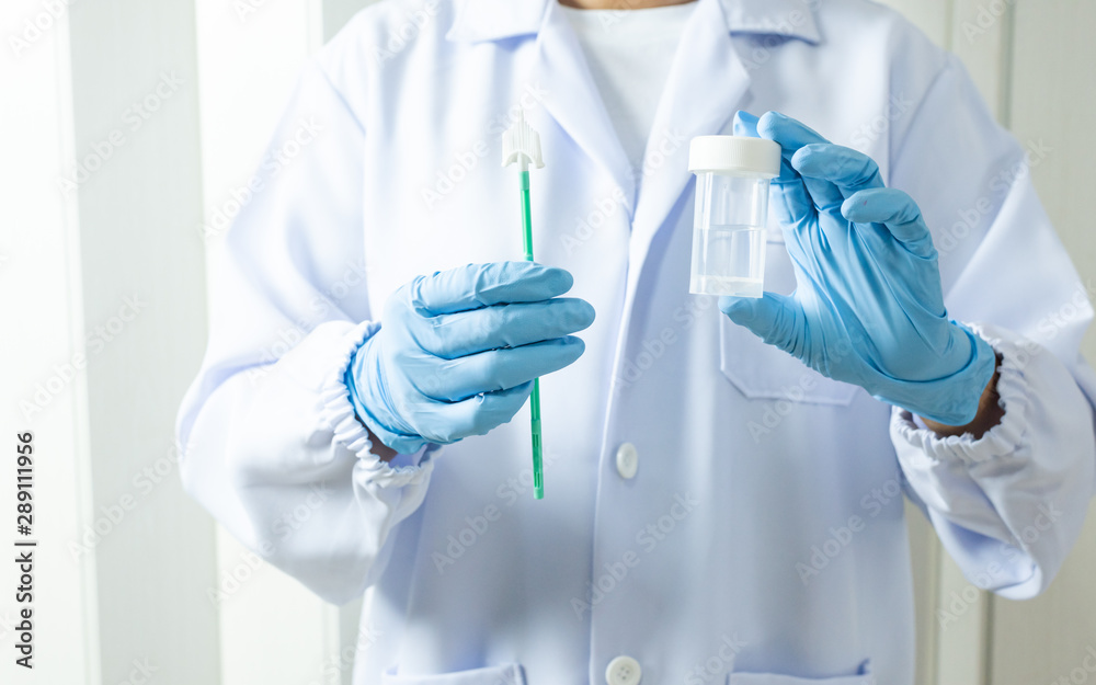 Doctor hand holding liquid base cytology set on blue background ...