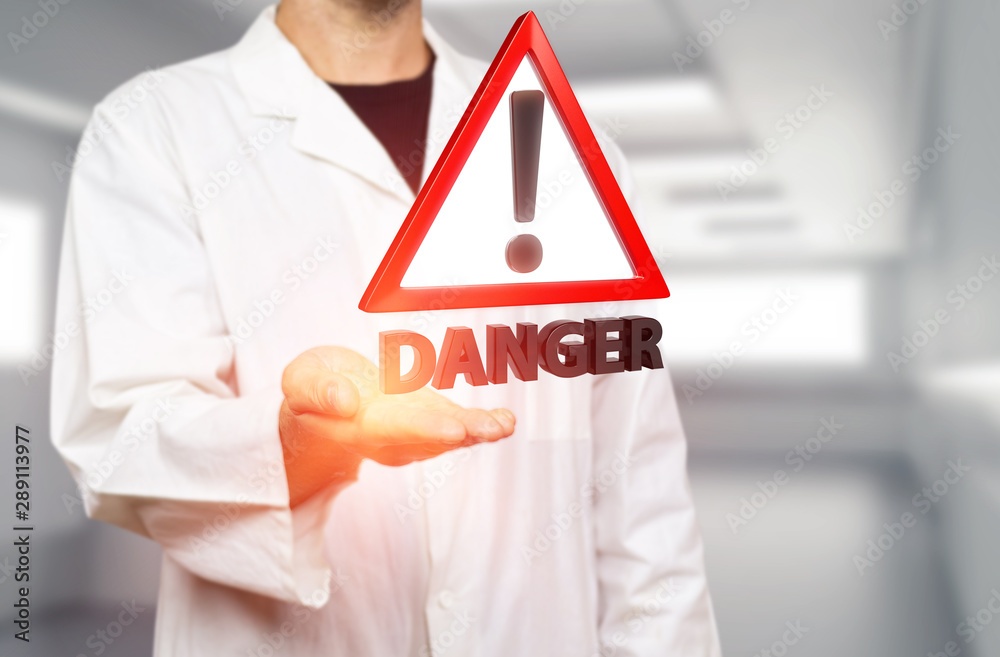 Young white scientist holding a red danger triangle warning sign on a ...