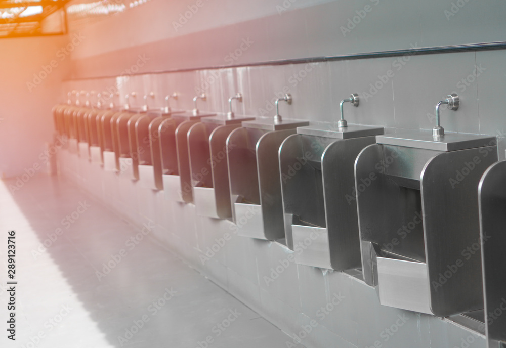 stainless urinals in men public toilet. stainless urinals in a row in ...