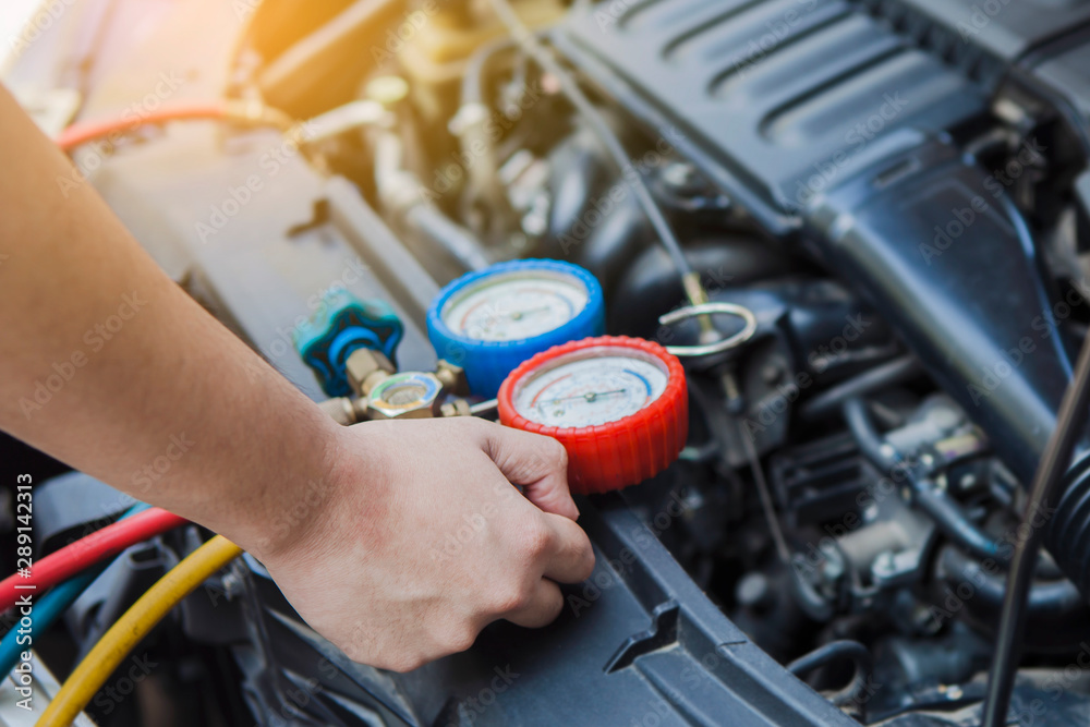 Auto mechanic Worker hands holding monitor to check and fixed car air ...