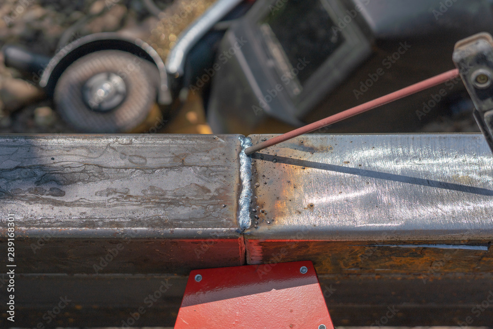 Welded seam on steel pipes. Weld tools. Welding housework. Stock Photo ...