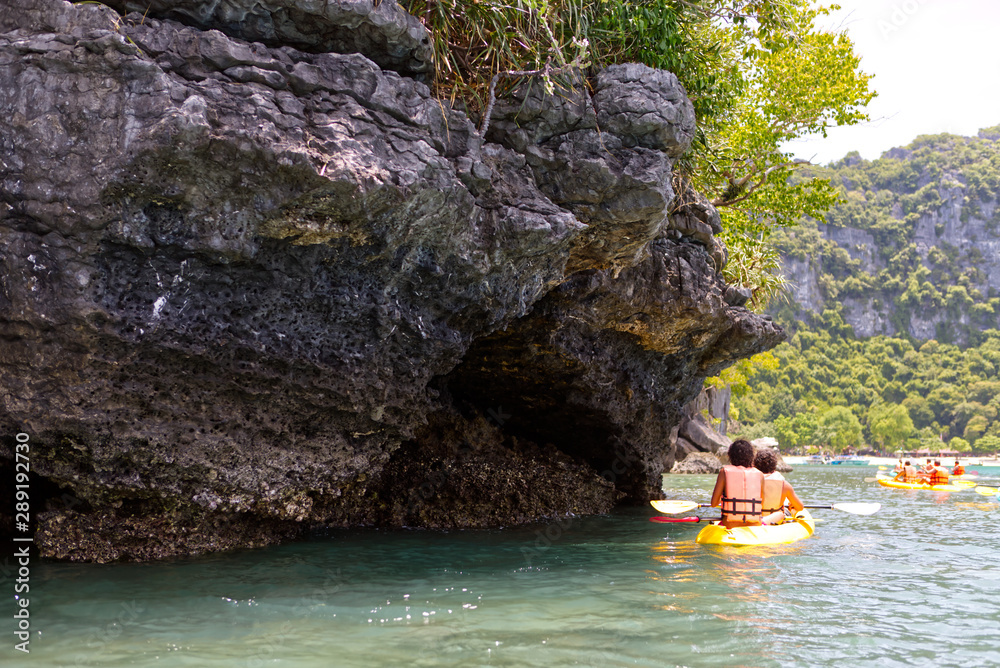 Fotka „Group of tourist kayaking in the ocean sea explore near the ...