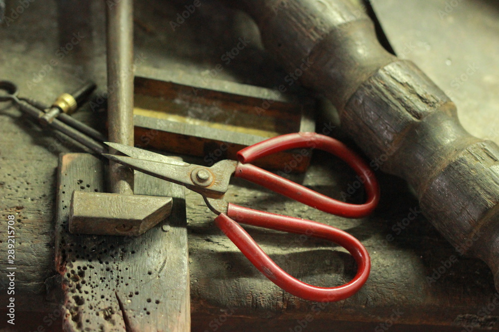 traditional worn and well used fine silversmiths tools on a craftsmans ...