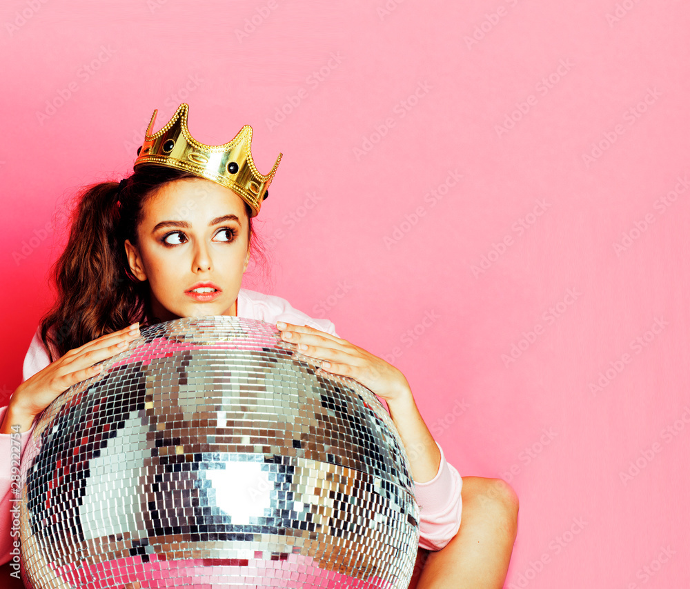 young cute disco girl on pink background with disco ball and crown ...