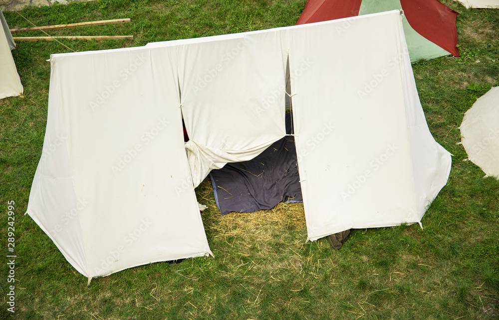 white vintage old tent with hay inside for sleeping in medieval ...
