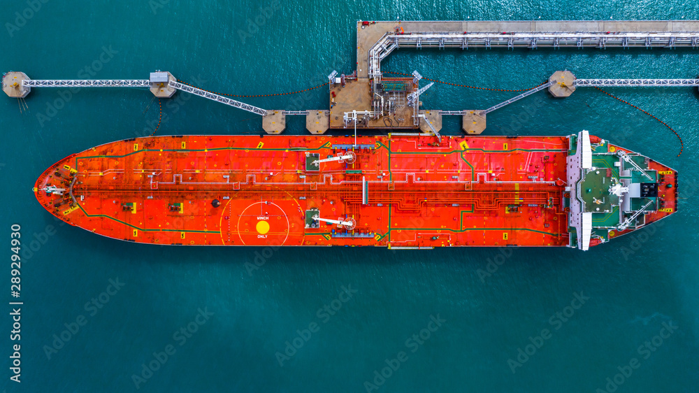 Aerial top view of fuel tanker ship at the port, Oil terminal is ...