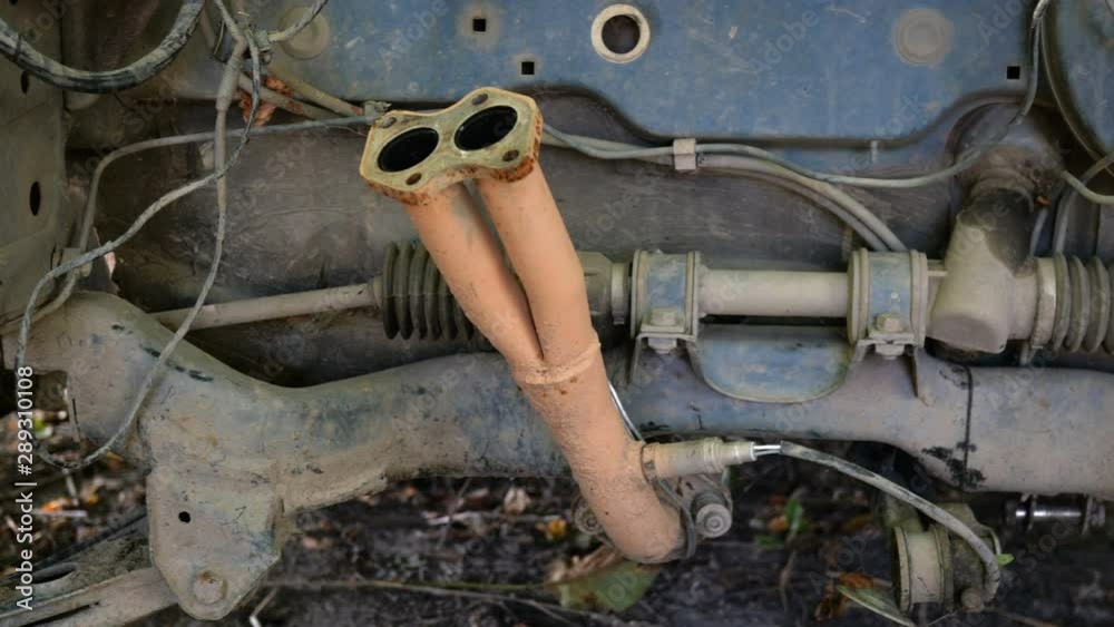 Parts of an old rusty abandoned car. Various disassembled parts and ...