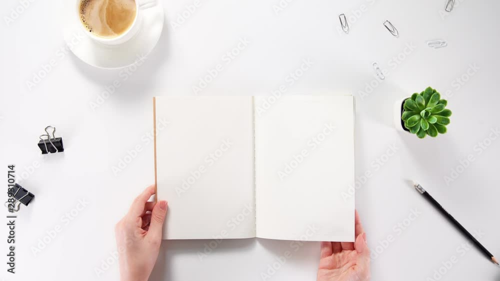 Woman hands turning over clean blank pages from recycled paper in big ...