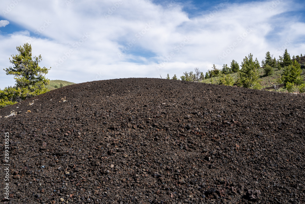 Hill of black volcanic rock at Crateres of the Moon National Monument ...