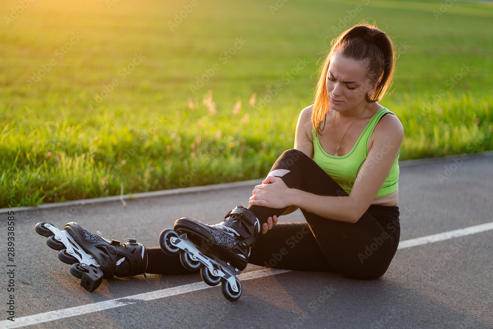 Woman injured knee while rollerblading. A teenager having a bruise ...