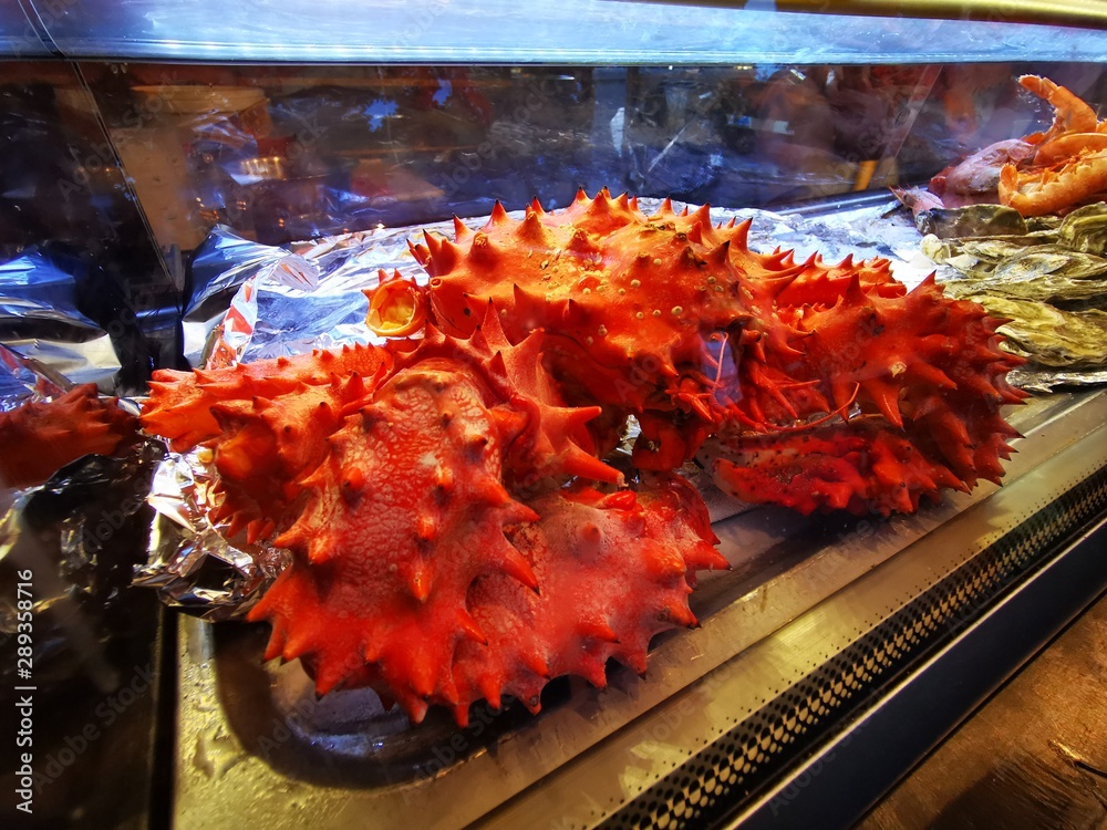 Spiked red king crab behind a glass window of a street cafe Stock Photo ...