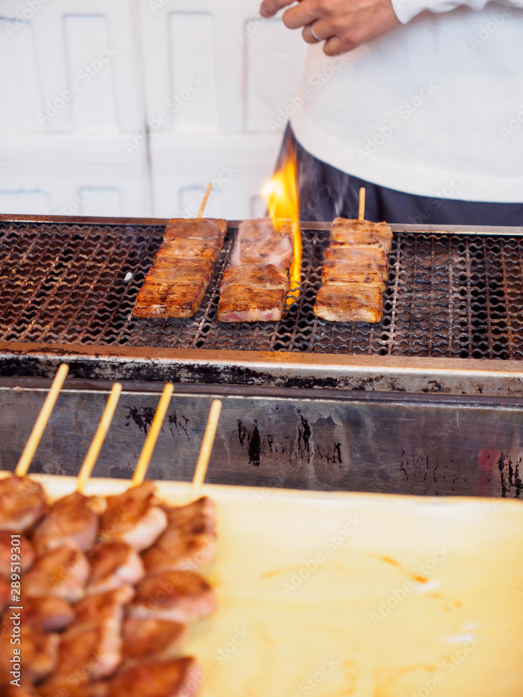Closeup vertical detail of beef skewers, Yakiniku Kushiyaki, roasting ...