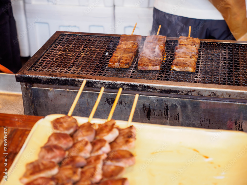 Closeup detail of beef skewers, Yakiniku Kushiyaki, roasting over a ...