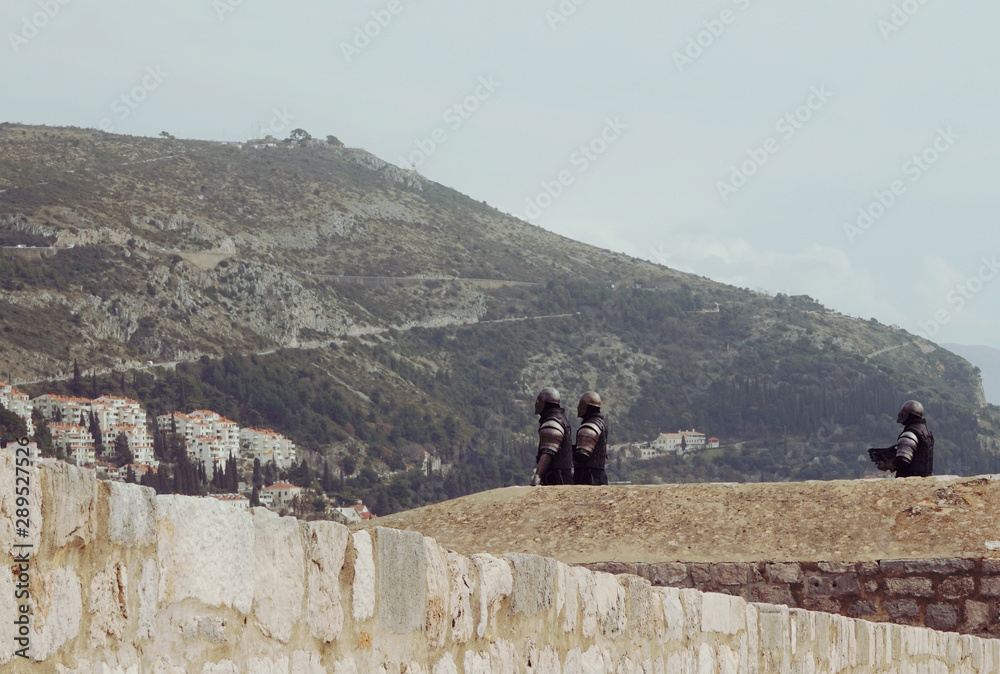 Medieval soldiers keeping watch on top of a stone wall Stock Photo ...