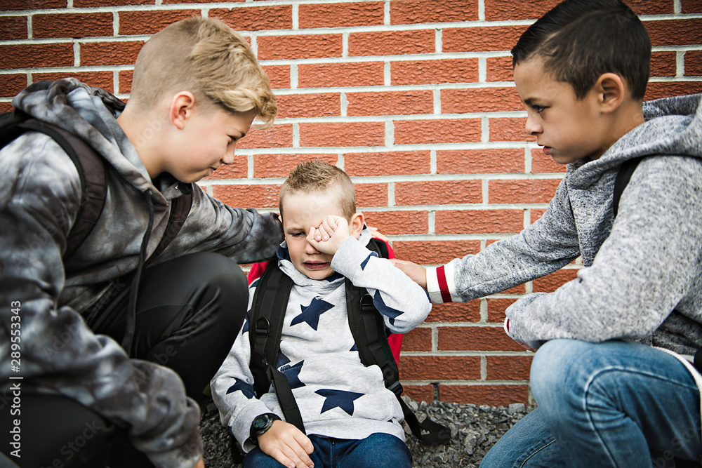 boy problem at school, sitting and consoling child each other Stock ...