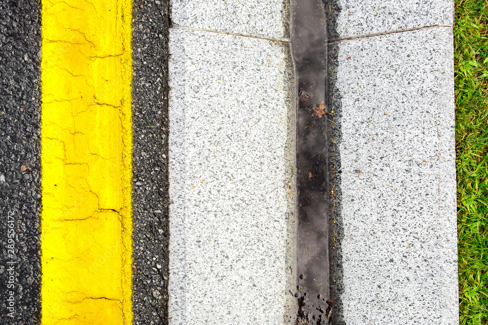 storm water channel concrete gutter with precipitation on the roadside ...