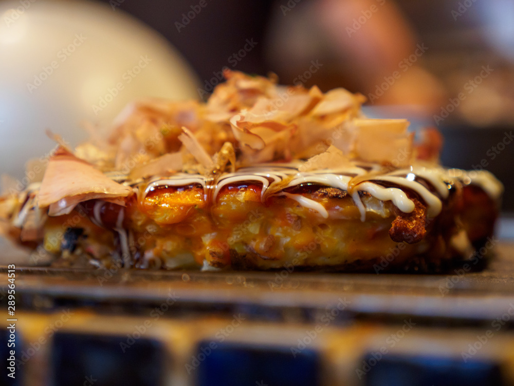Macro detail of a freshly cooked Okonomiyaki with Katsuobushi, dried ...