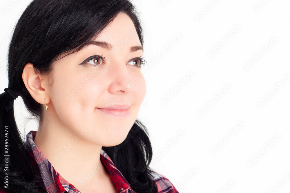 A young joyful beautiful brunette girl with cute dimples on her cheeks ...