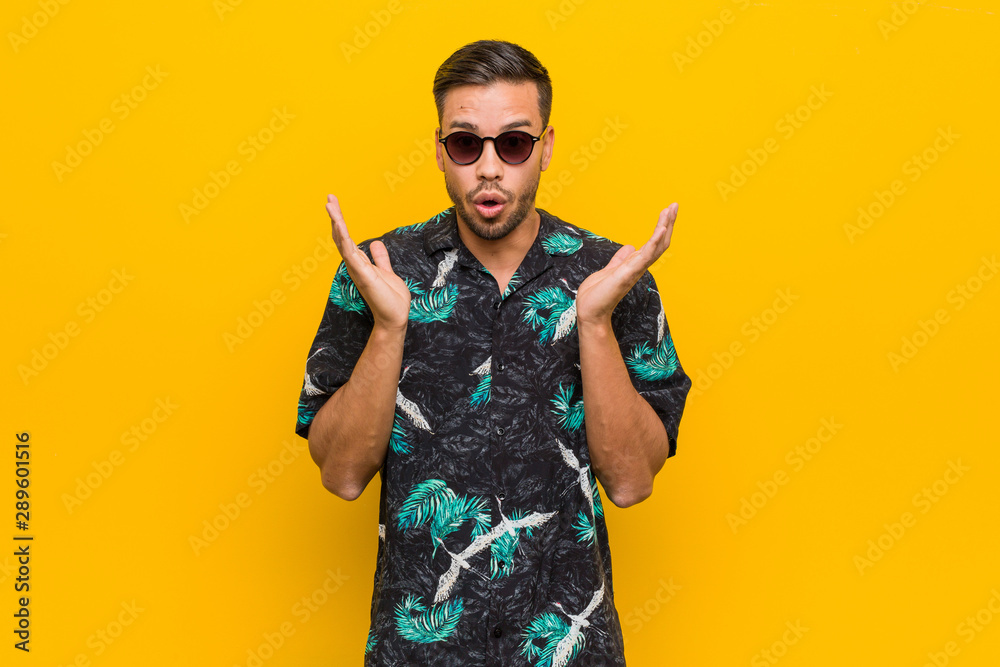 Young filipino man wearing summer clothes surprised and shocked. Stock ...