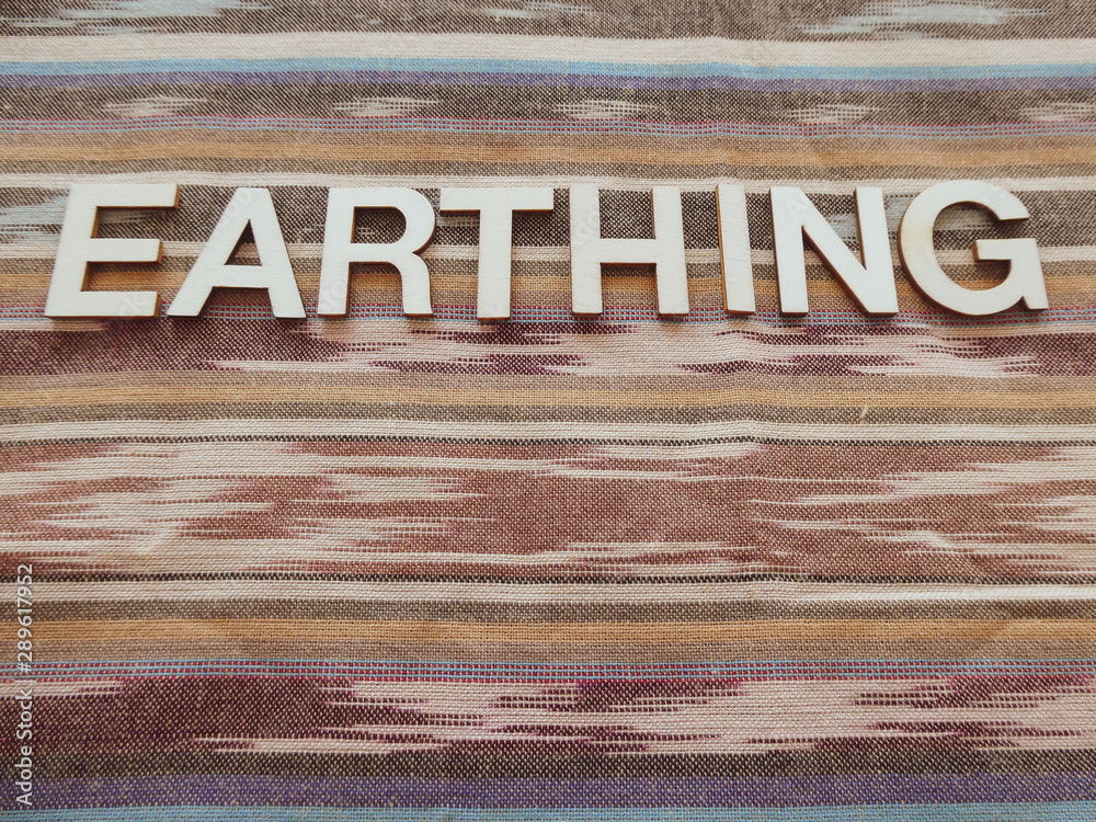 Wooden text letters with the word "EARTHING" for a sign, banner ...