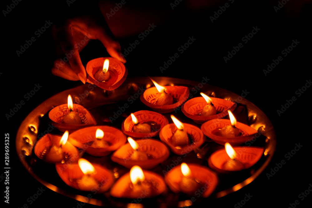Festival Of Lights. Indian woman or girl holding lit traditional clay ...