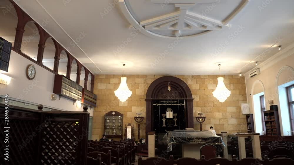 Classical interior of the Synagogue: shell rock wall, chairs ...