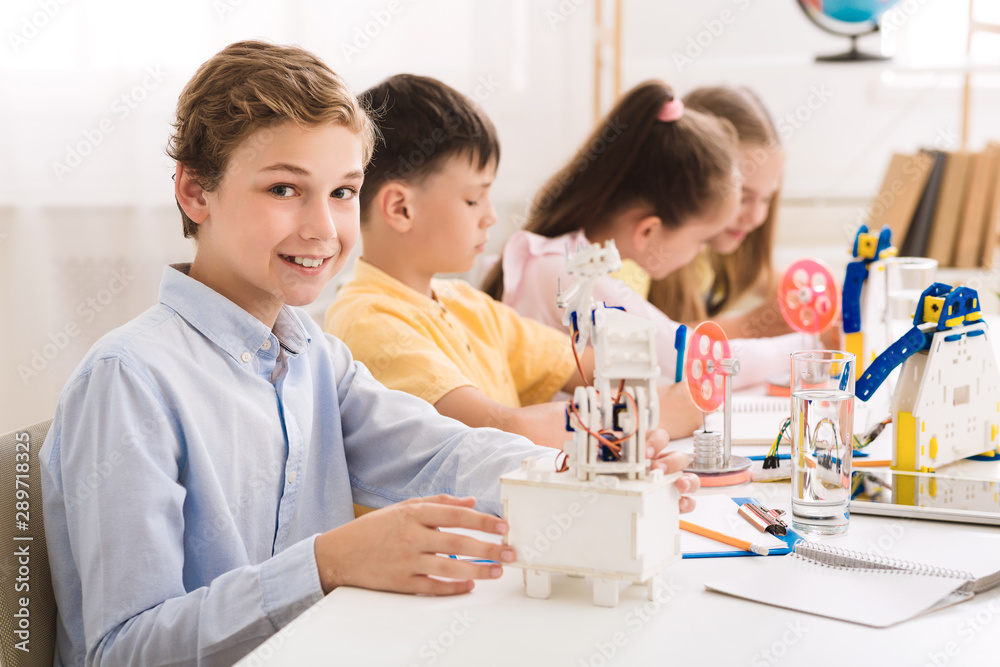 Schoolboy creating robot at lab, smiling to camera Stock Photo | Adobe ...