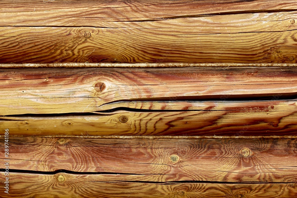 Part of the wall of the log house. Textured pine logs laid on each ...