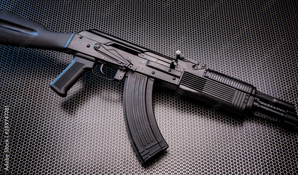 FM AK rifle on metal grid background. Stock Photo | Adobe Stock