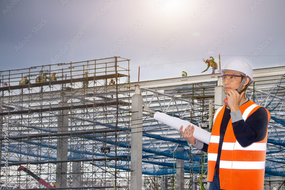 Asian engineer wearing safety helmet and safety glasses holding ...