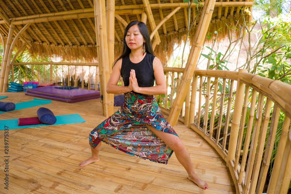 young natural and attractive Asian Chinese woman practicing yoga and ...