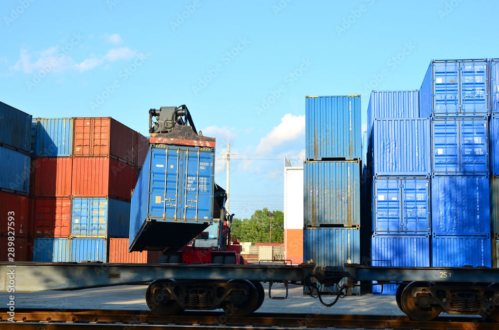Shipping container loading by richtracker on the freight rail car at ...