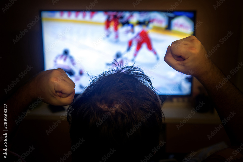 The back view of excitement man with gesturing hands up how watching ...