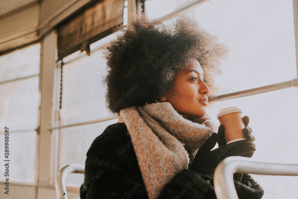 Beautiful girl with afro haircut portraits in the public transport ...