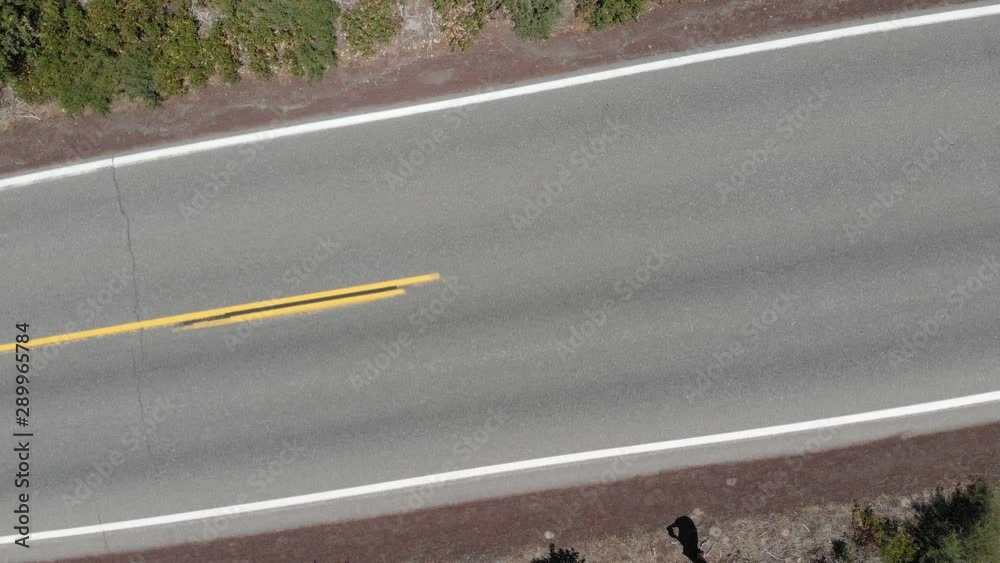 Looking down at a empty road, going up, turning clockwise revealing the ...