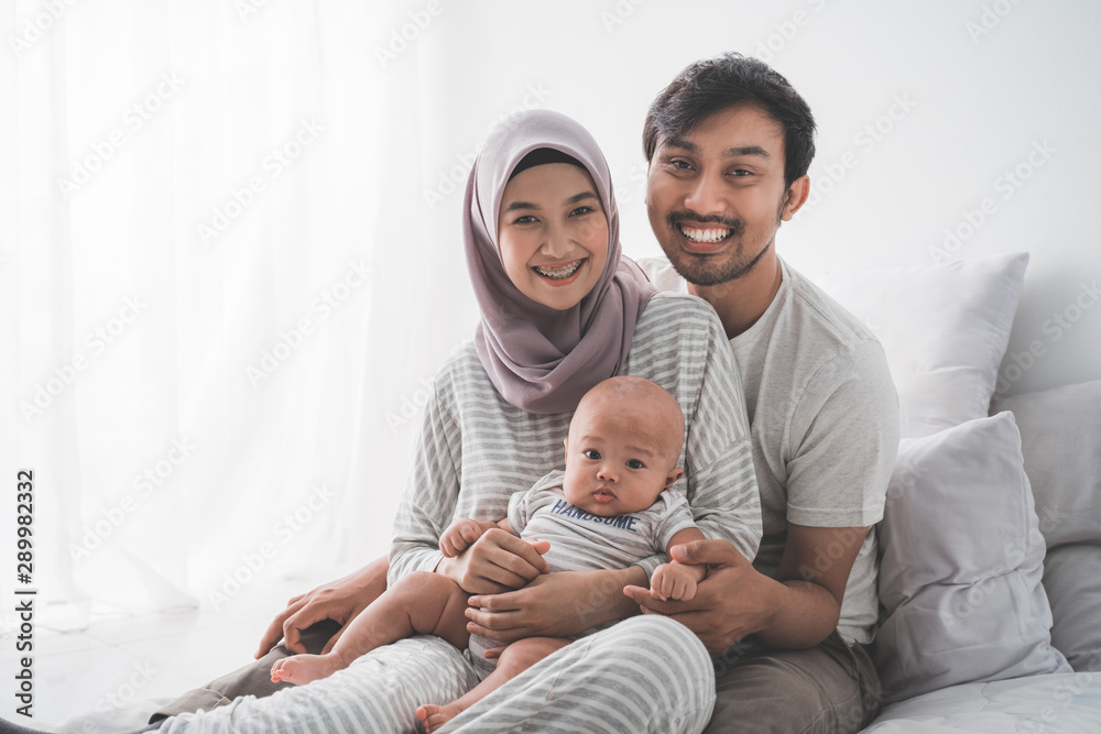 muslim parent with baby boy smiling to camera Stock Photo | Adobe Stock