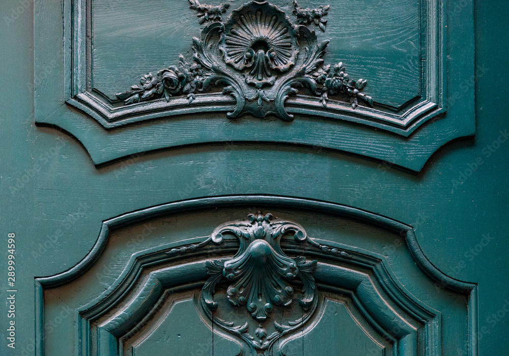 Details of gorgeous antique wooden door with curved frames and baroque ...