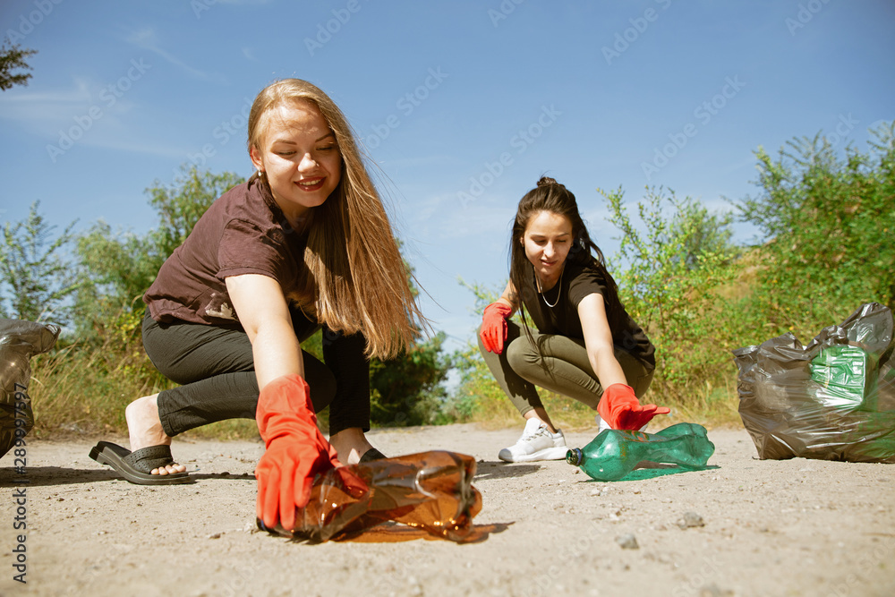 Clean our home together. Group of volunteers tidying up rubbish on ...