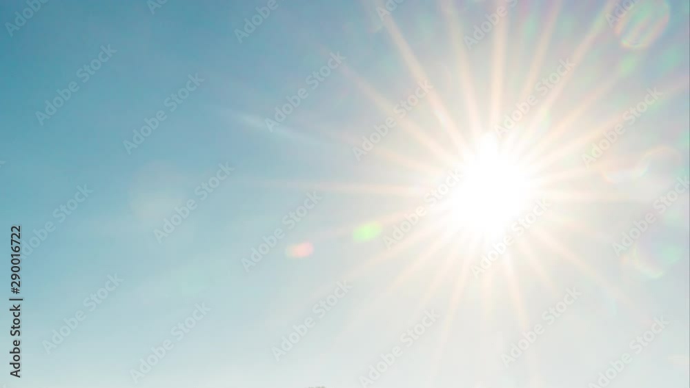 Beautiful sun with scenery sun rays and lens flare in blue sky. 4k Time ...