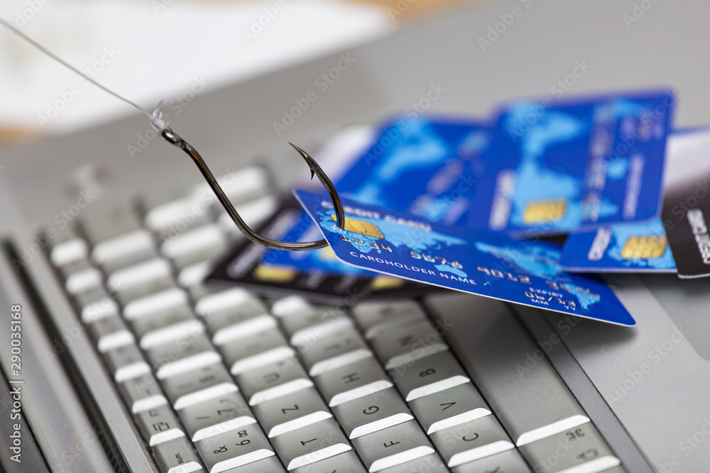 Credit card phishing. Piles of credit cards with a fish hook on ...