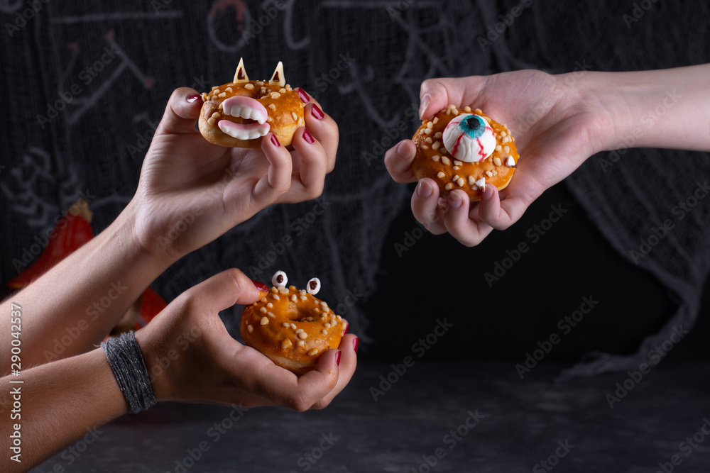 Scary Halloween donuts with teeth and eyes on dark background. Three ...