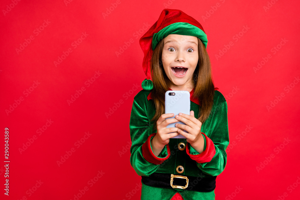 Portrait of shocked elf in green hat cap with long red head screaming ...