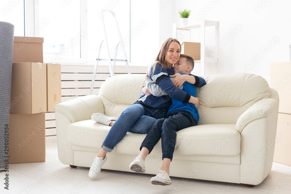 Cute single mom and little boy son relaxing after the move. The concept ...