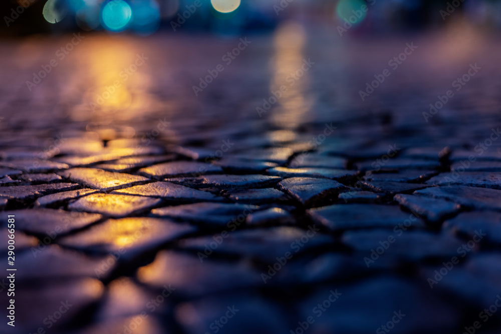 paving stones with reflection and lens flare night lights, night city ...