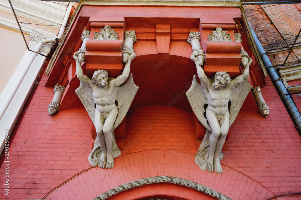 Architectural sculptures two gargoyles under the balcony, view from ...