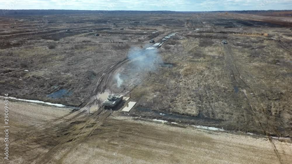 An aerial view of a shooting tank in the middle of a field. The machine ...