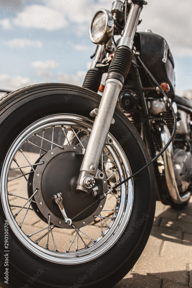 The front wheel of the motorcycle with a drum brake and a cable to it ...