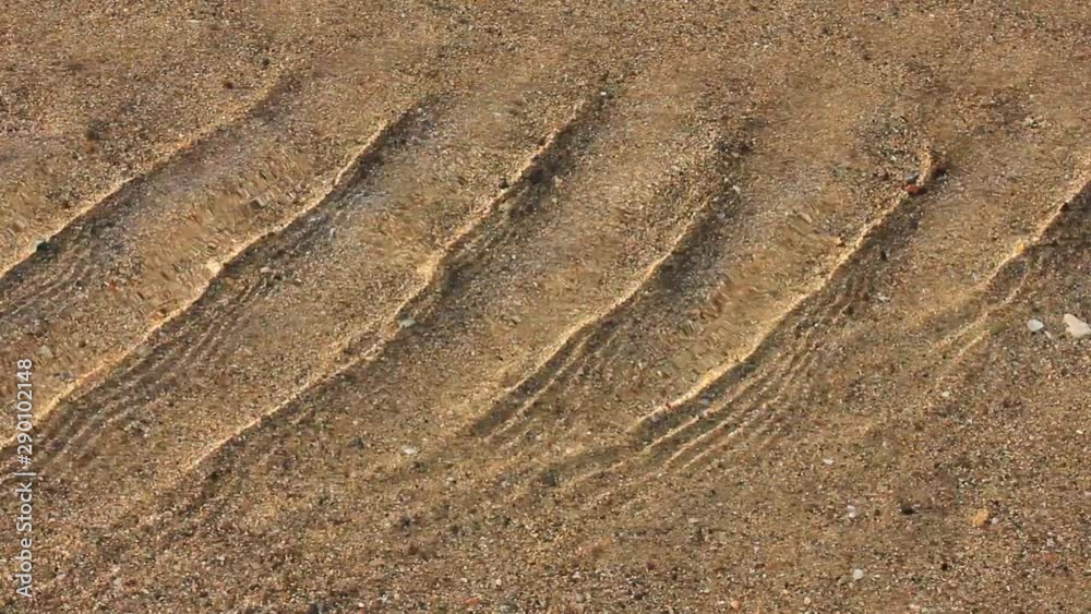 Moving wavy patterns and forms from sand grains particles carried out ...