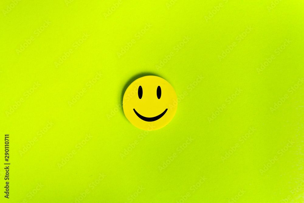 Positive Funny smiley face on a green cardboard background. Copy space ...
